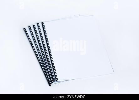 Binded documents with plastic spiral on white background Stock Photo ...