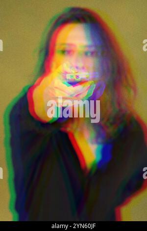 Woman holding remote control aimed at the air conditioner Stock Photo ...