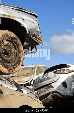 Vehicles are seen piled up after being swept away by floods on a ...