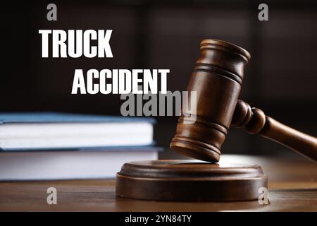 Truck accident law. Wooden judge's gavel and book on marble table, top ...