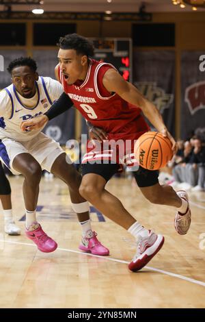 Wisconsin guard John Tonje drives up court during the first half of an ...