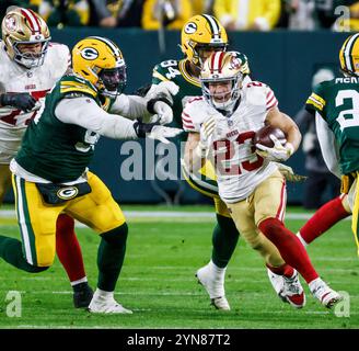 Green Bay Packers' Devonte Wyatt rides a bike to an NFL football joint practice session with the ...