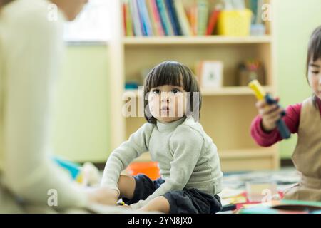 Children learning in toddler classroom Stock Photo - Alamy