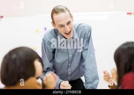 Teachers and children giving an English lesson Stock Photo - Alamy