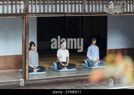 Three women doing zazen Stock Photo - Alamy