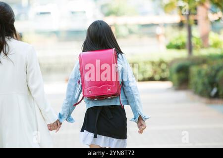 Back view of schoolgirl carrying a bag Stock Photo - Alamy