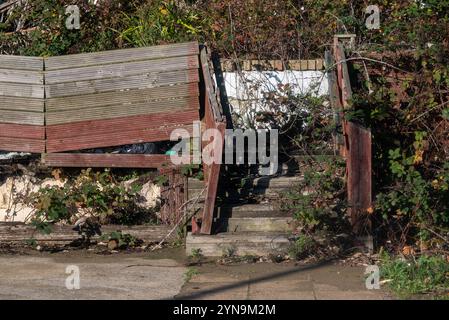 Old rusted and derelict wall and staircase outside of an empty building ...