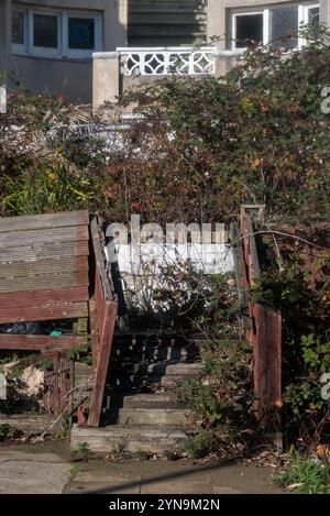 Old rusted and derelict wall and staircase outside of an empty building ...