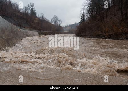Raging Floodwaters Surge Through a Rain-Swept River Valley Stock Photo ...