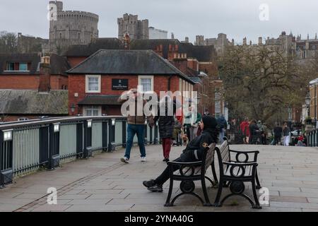 A man holds onto his hat during a race before the147th running of the ...