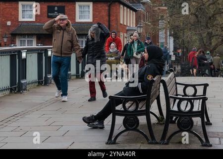 A man holds onto his hat during a race before the147th running of the ...