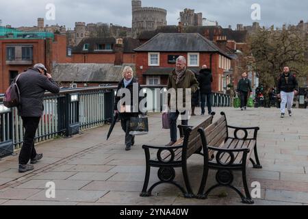 A man holds onto his hat during a race before the147th running of the ...