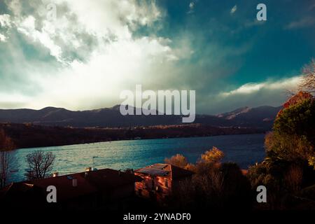 Scenic view of lake by buildings against sky during sunset Stock Photo ...
