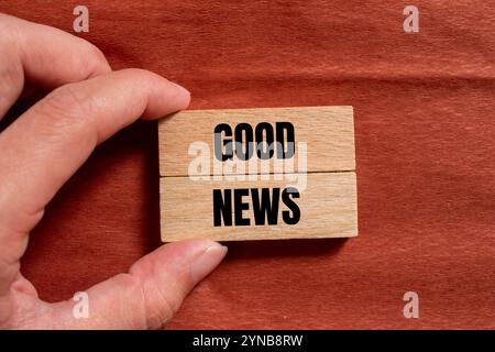 Good news message written on ripped torn yellow paper with purple ...