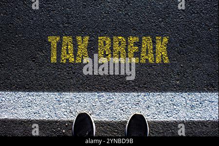 Tax break message written on ripped torn paper piece with cardboard ...