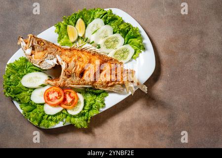 Deep fried crispy grouper fish with sambal dabu dabu Stock Photo - Alamy