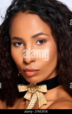 A stunning woman showcases her beauty and poise in an artistic display ...