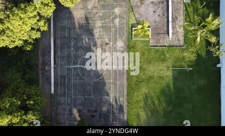 Aerial top-down photo of multisport court degraded by time in a tree ...