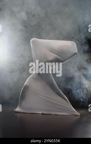 Artistic representation of a cloaked figure emerging from mist Stock ...