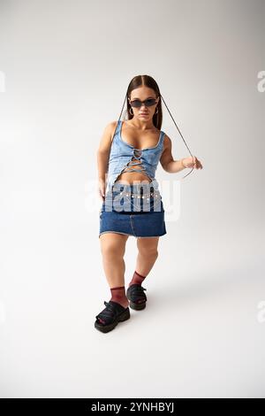 A young woman with short stature models trendy denim outfits in a ...