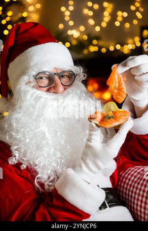 Jolly Santa Claus eating gravlax sandwich, traditional Scandinavian and ...