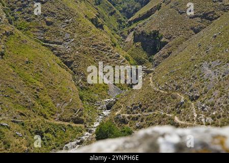A serene view of a bridge overlooking a calm blue sea with clear skies ...