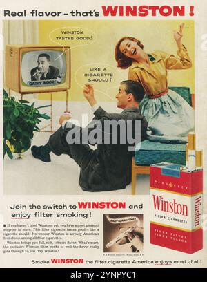 1950s BUSINESS MAN SMOKING A CIGARETTE RELAXED WITH HIS FEET UP ON THE ...