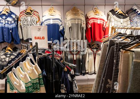 Rack with warm sweaters in interior of stylish room Stock Photo - Alamy