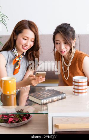 Girl operating smartphone in room Stock Photo - Alamy