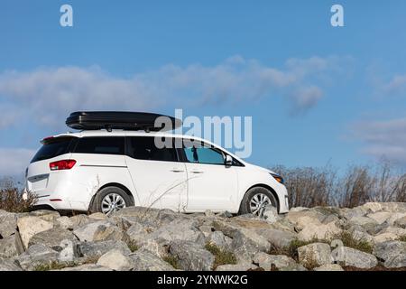 White SUV Car with the roof rack cargo box on road in Untertauern ...