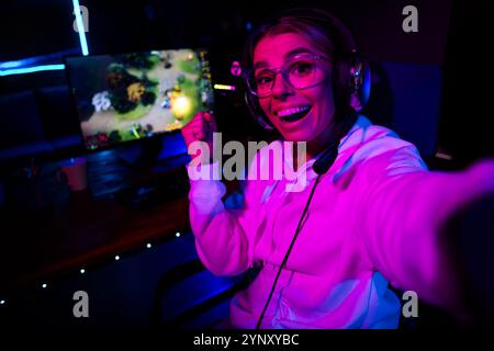 Photo of gamer lovely blonde young lady toothy smile play strategy game ...