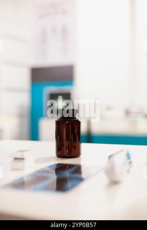 pill container and x-ray in focus on medical office desk. Closeup of ...