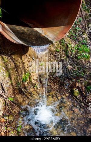 Water falling into a stream from a culvert Stock Photo - Alamy
