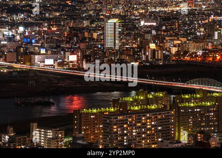 Highway and railway bridges crossing the Yodo River, night skyline ...