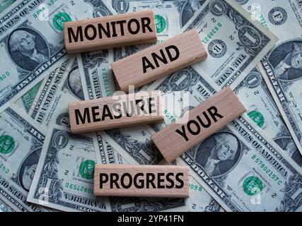 Monitor and Measure your Progress symbol. Wooden blocks with words ...