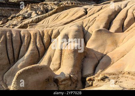 Rugged volcanic landscape with rocky ridges under a cloudy sky at dusk ...