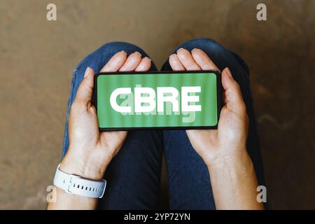 In this photo illustration, the CBRE Group logo is displayed on a ...