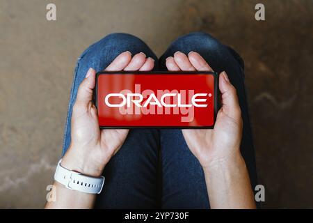 In this photo illustration, an ORACLE logo is displayed on a smartphone ...