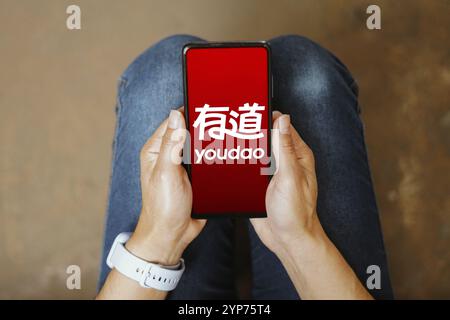 In this photo illustration, the Youdao logo seen displayed on a ...