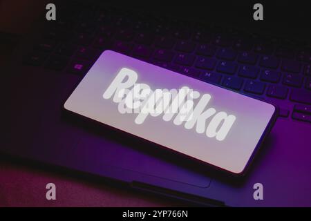 In this photo illustration, the Replika logo is displayed on a ...