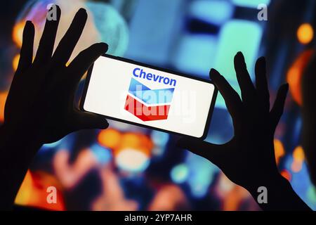 In this photo illustration, the Chevron logo is seen displayed on a ...
