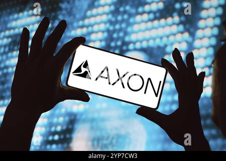 In this photo illustration, Axon logo is seen on a mobile phone with ...