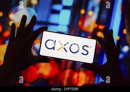 In this photo illustration, the Axos logo is displayed on a smartphone ...