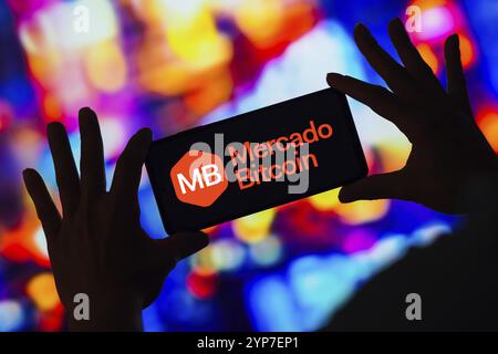 In this Photo illustration, a Bitcoin is seen on a background of a one ...