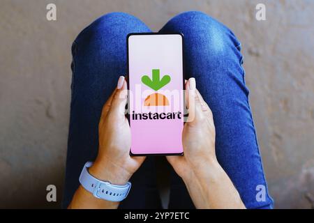 In this photo illustration, the Instacart logo is displayed on a ...