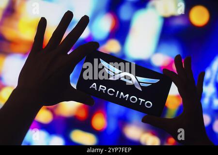 In this photo illustration the Arcimoto logo seen displayed on a ...