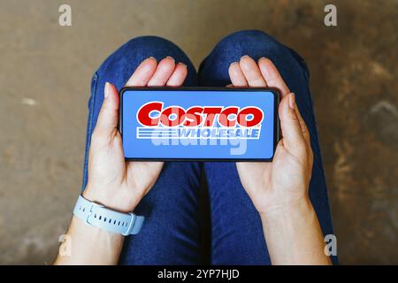 In this photo illustration a Costco Wholesale logo seen displayed on a ...