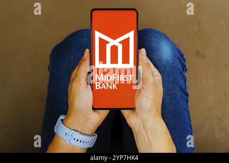 In this photo illustration, the MidFirst Bank logo is displayed on a ...