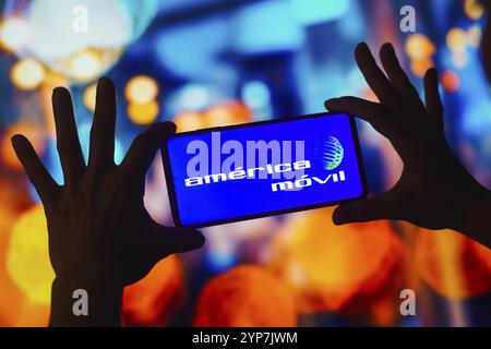In this photo illustration an America Movil logo of a ...