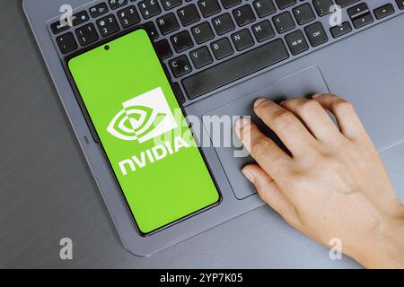 In this photo illustration, the NVIDIA logo is displayed on a ...